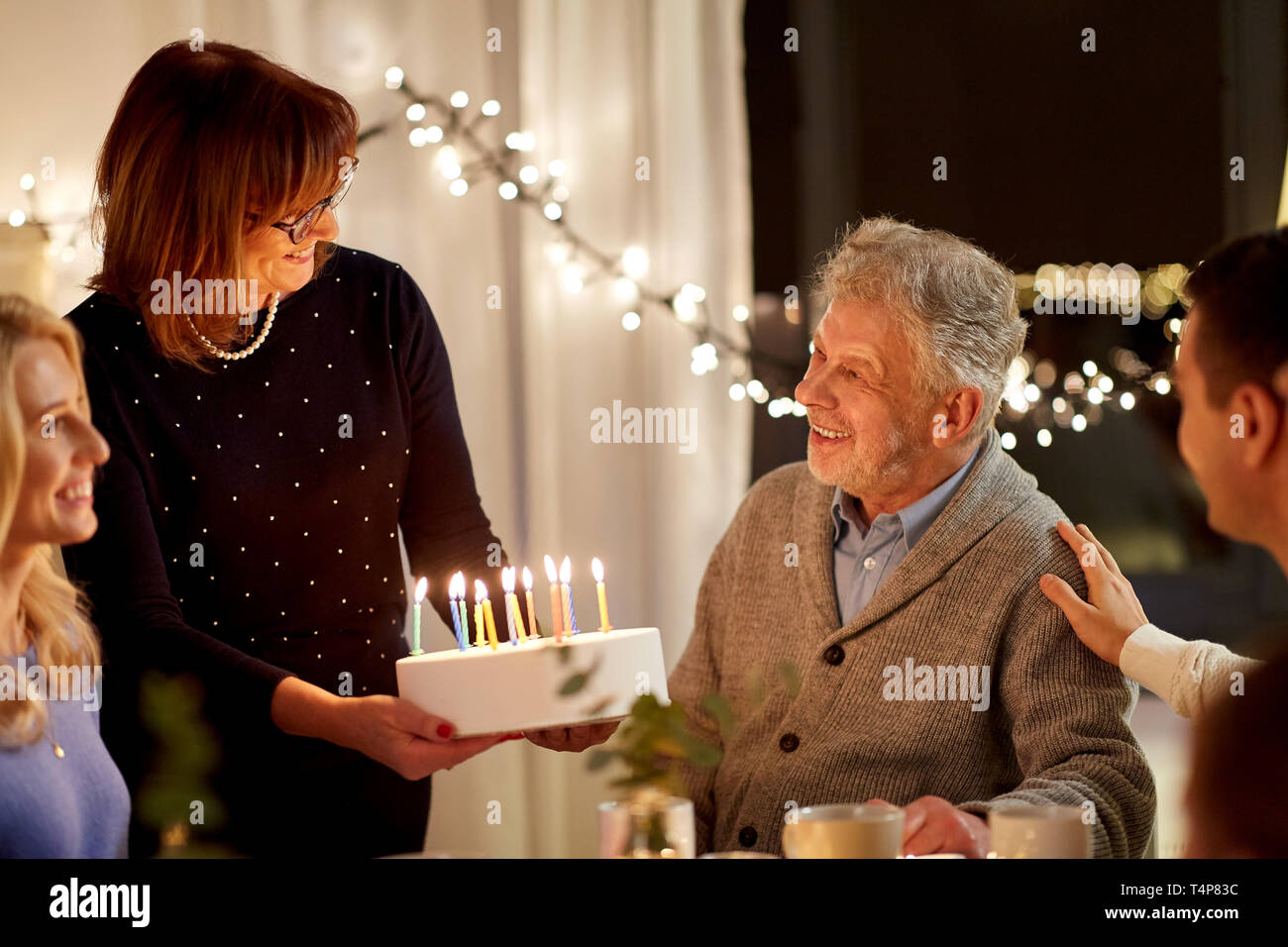 celebration and family concept - happy family having birthday party at ...