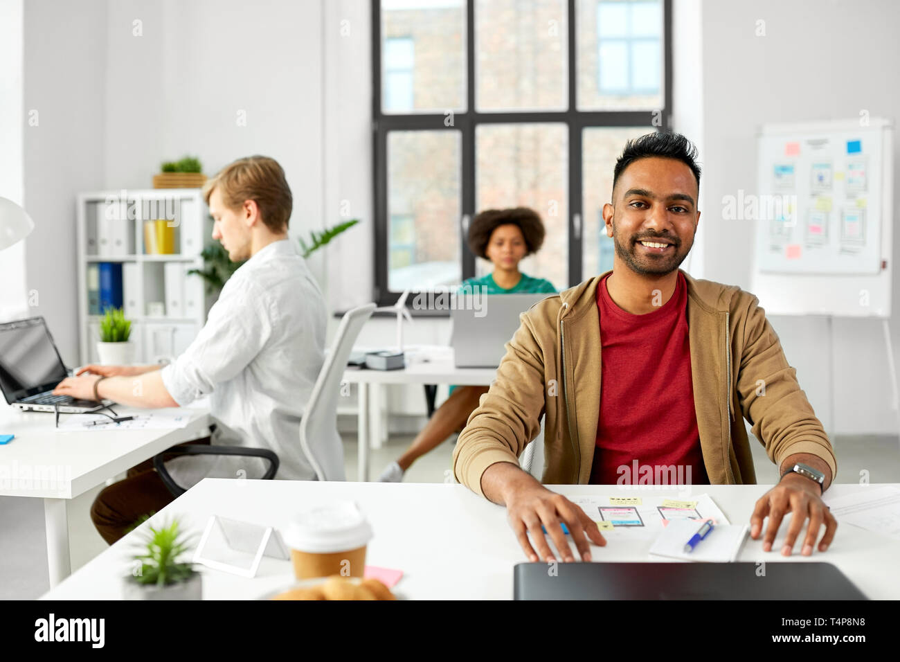 business and people concept - happy smiling indian male creative worker ...