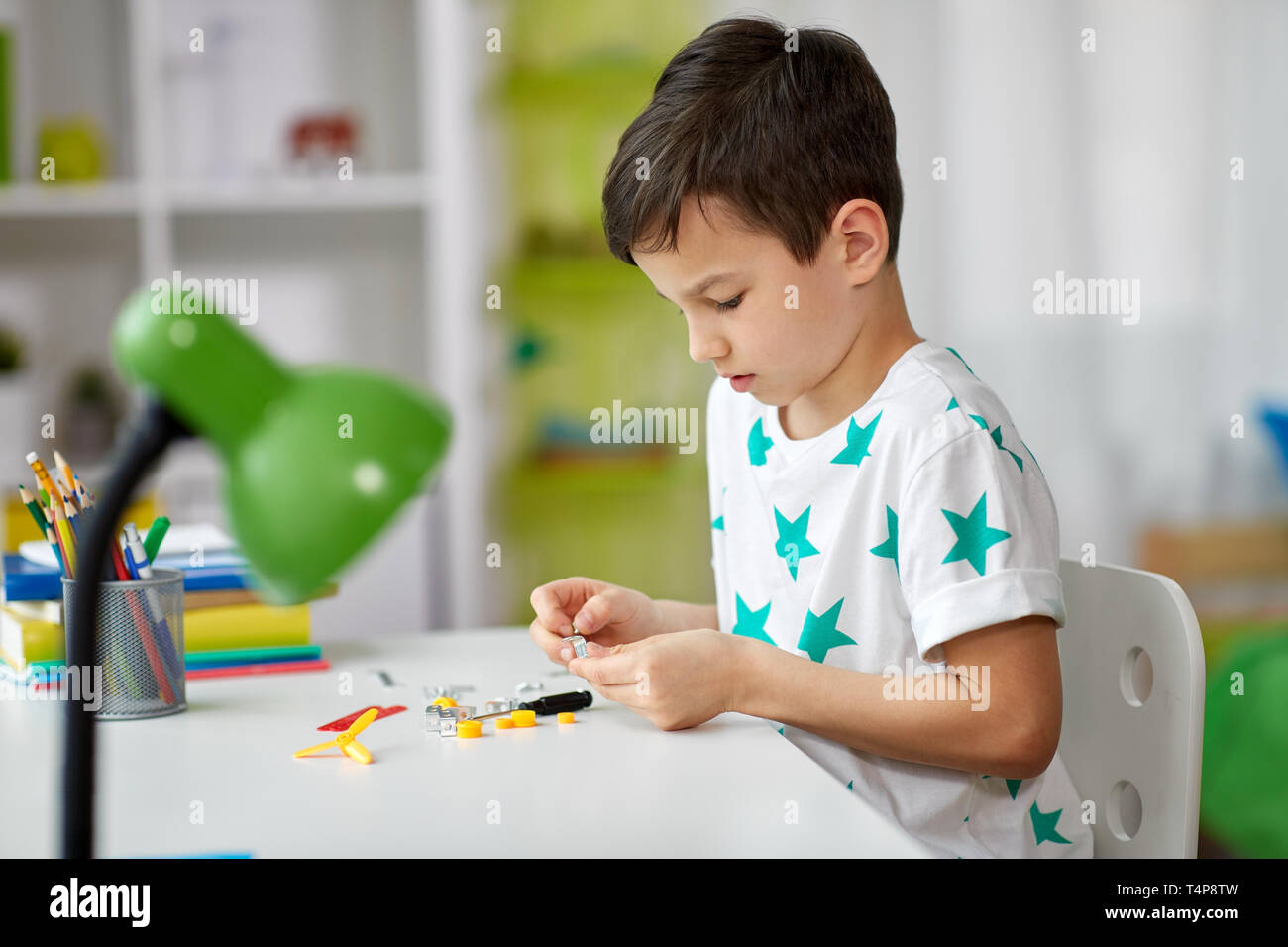 childhood, hobby and leisure concept - little boy playing with building ...