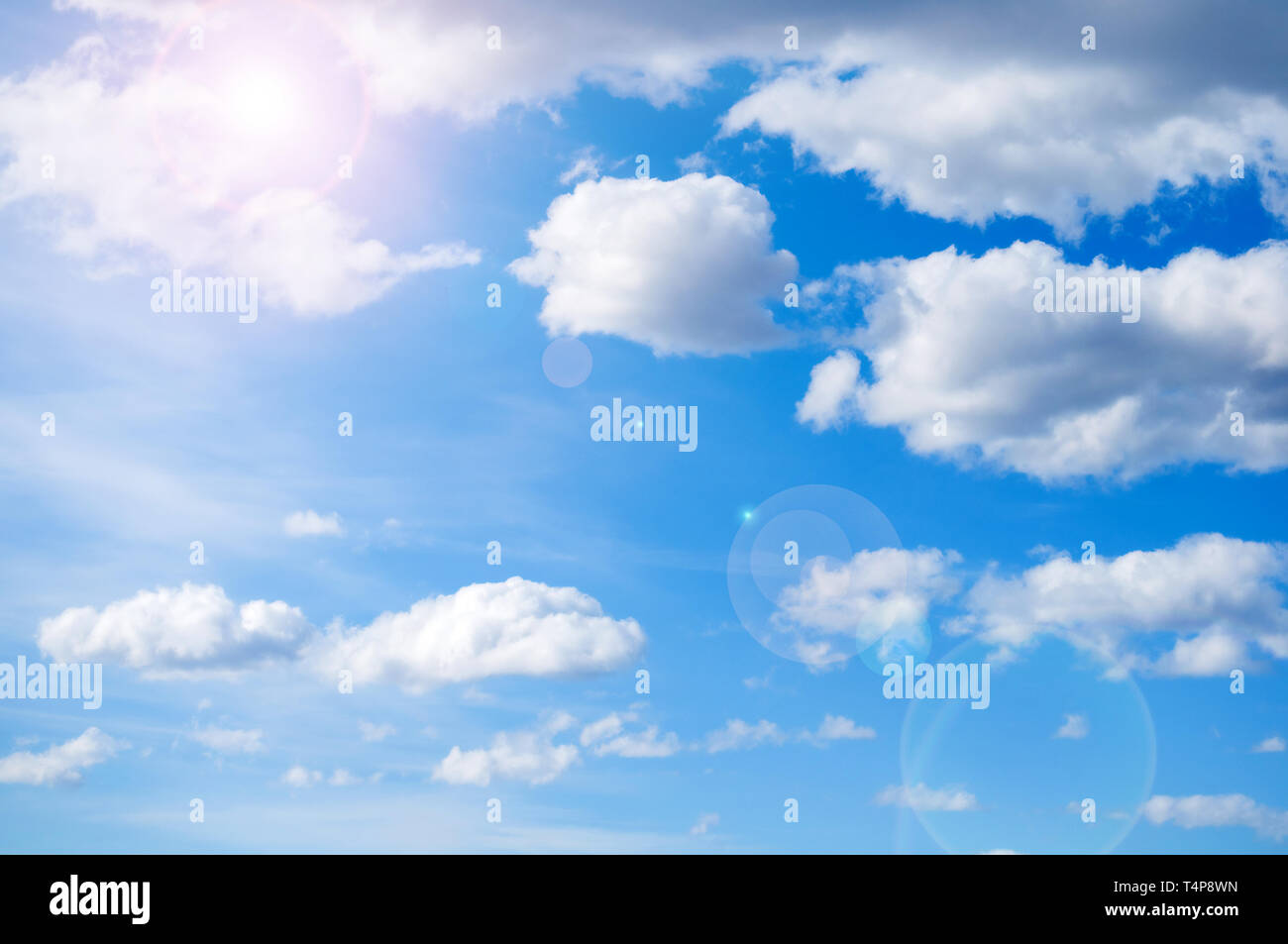 Blue sky background with white dramatic colorful clouds and sunlight ...