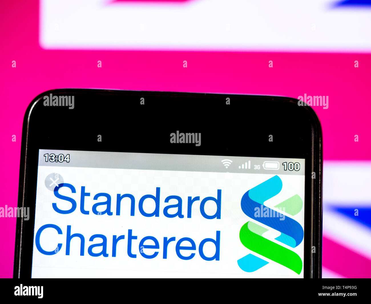 In this photo illustration a Standard Chartered PLC logo seen displayed ...