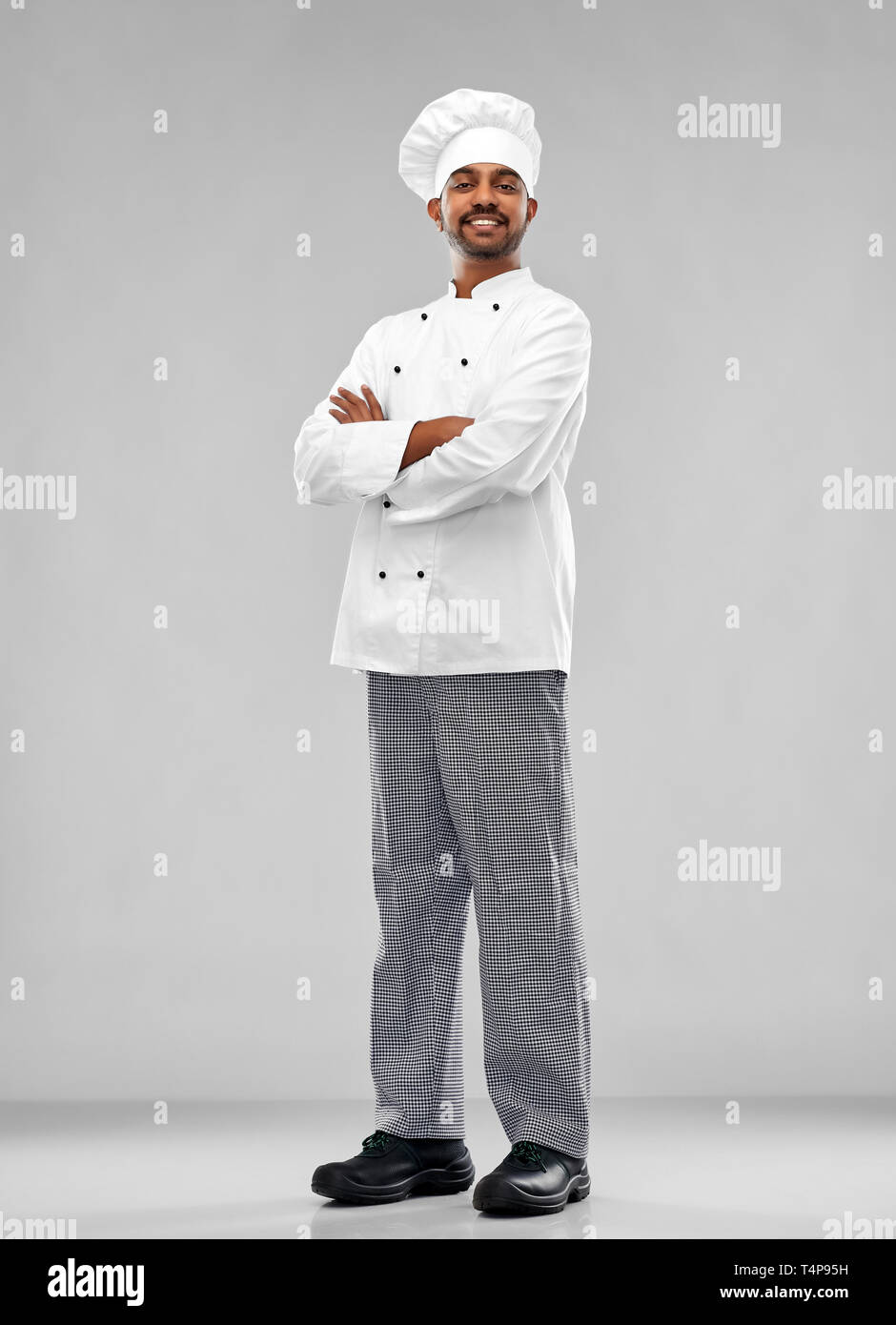 cooking, profession and people concept - happy male indian chef in ...