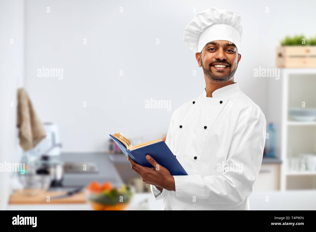cooking, profession and people concept - happy male indian chef in ...