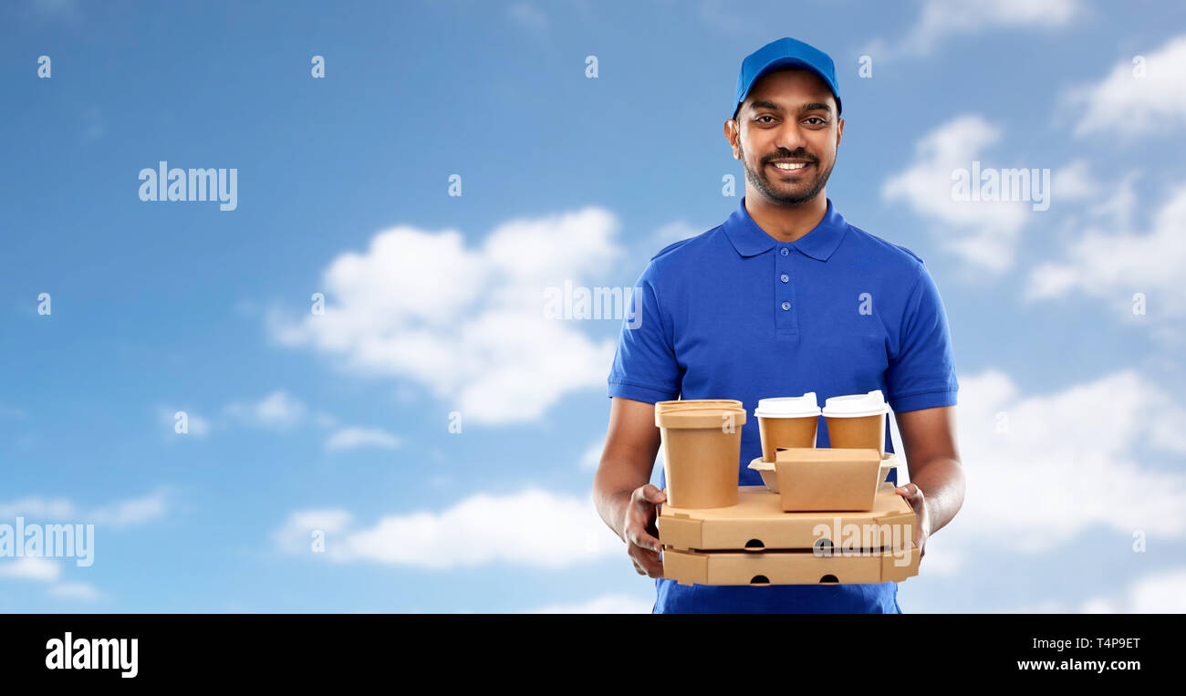 service and people concept - happy indian delivery man with food and ...