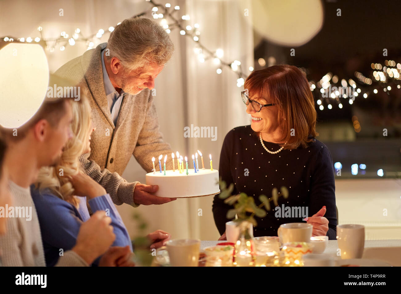 celebration and family concept - happy family having birthday party at ...