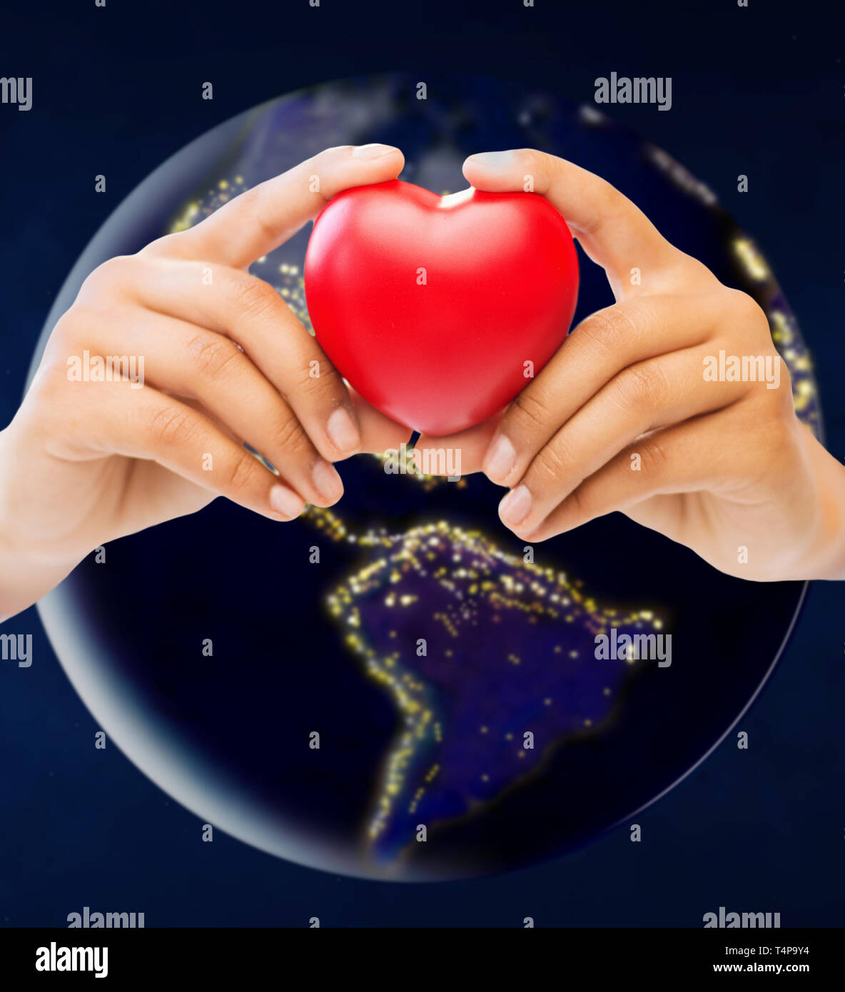 love, environment and charity concept - hands holding red heart over ...