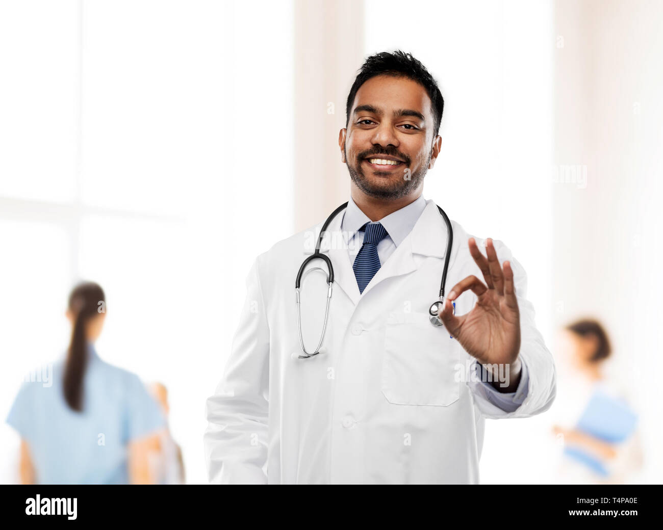 medicine, gesture and healthcare concept - smiling indian male doctor ...
