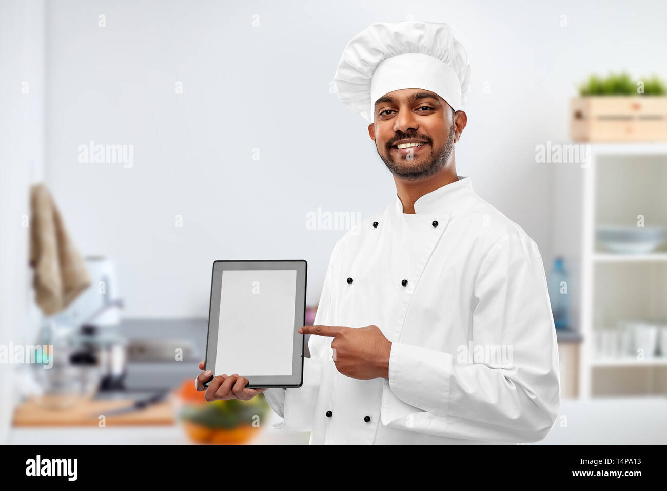 cooking, technology and people concept - happy male indian chef in ...