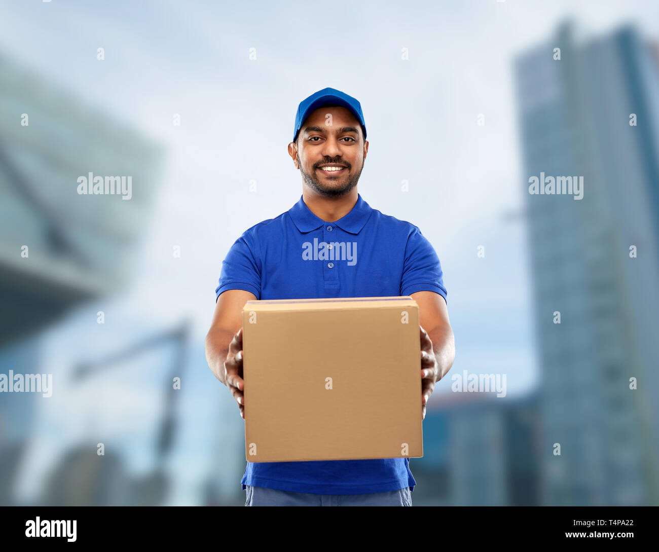 mail service and shipment concept - happy indian delivery man with ...