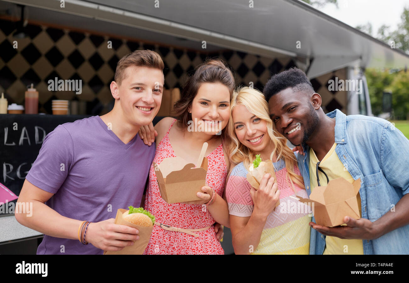 leisure, eating and people concept - happy friends with wok and burger ...