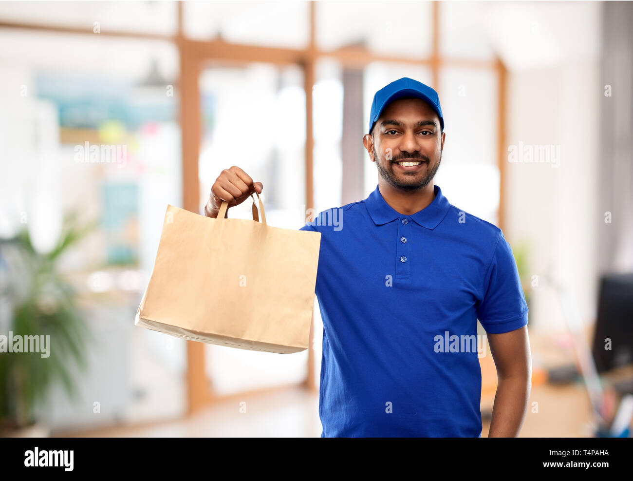 takeaway service and people concept - happy indian delivery man food in ...