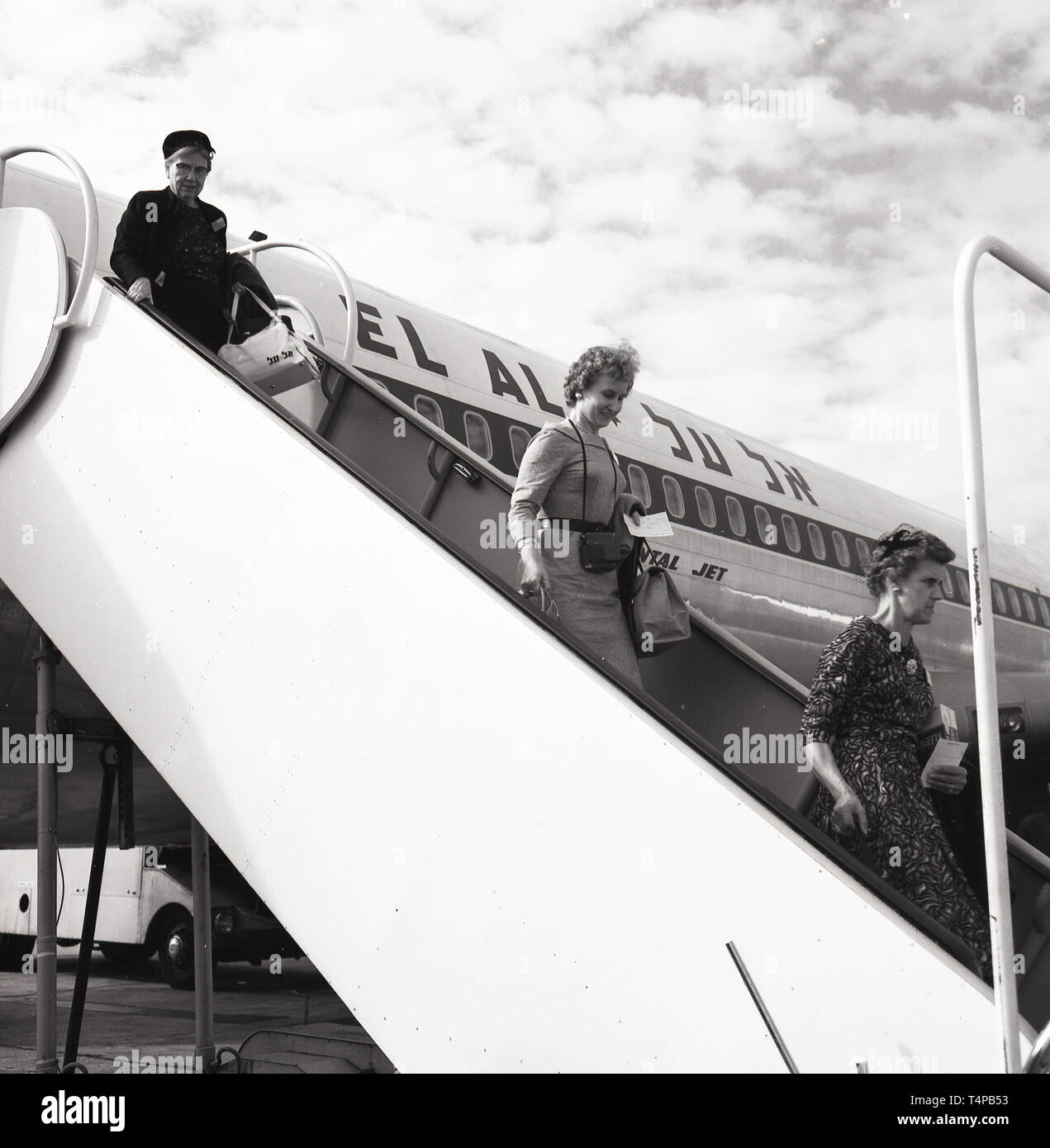 1960s, historical, adult female passengers disembark down some steps ...