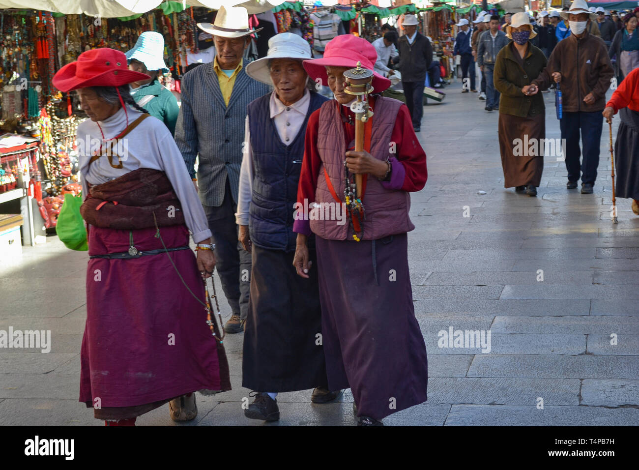 Pilgrims of Tibetan Buddhism, monks, locals, and tourists walking ...