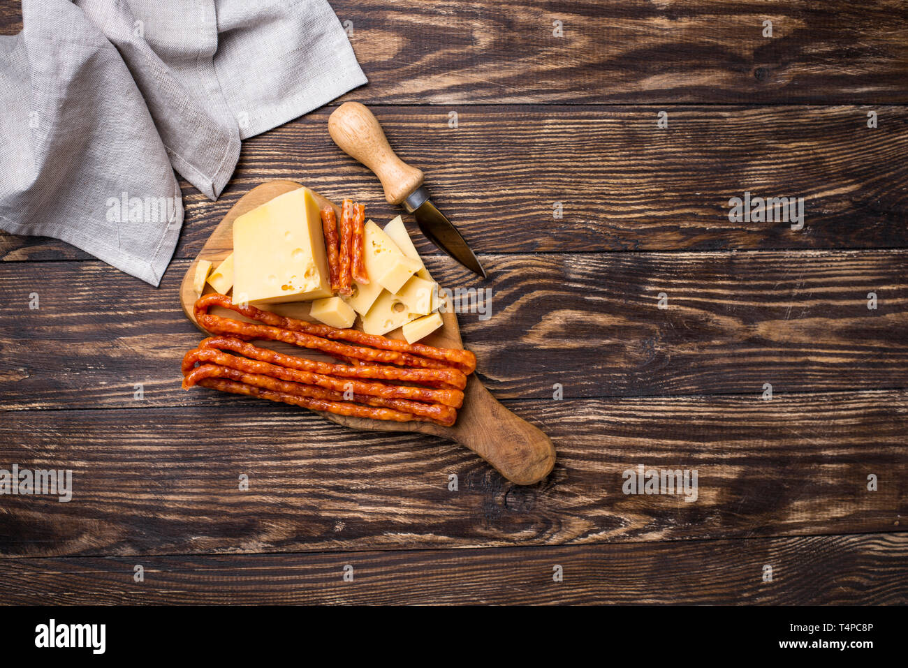 Cheese and salami sausage on wooden board Stock Photo - Alamy