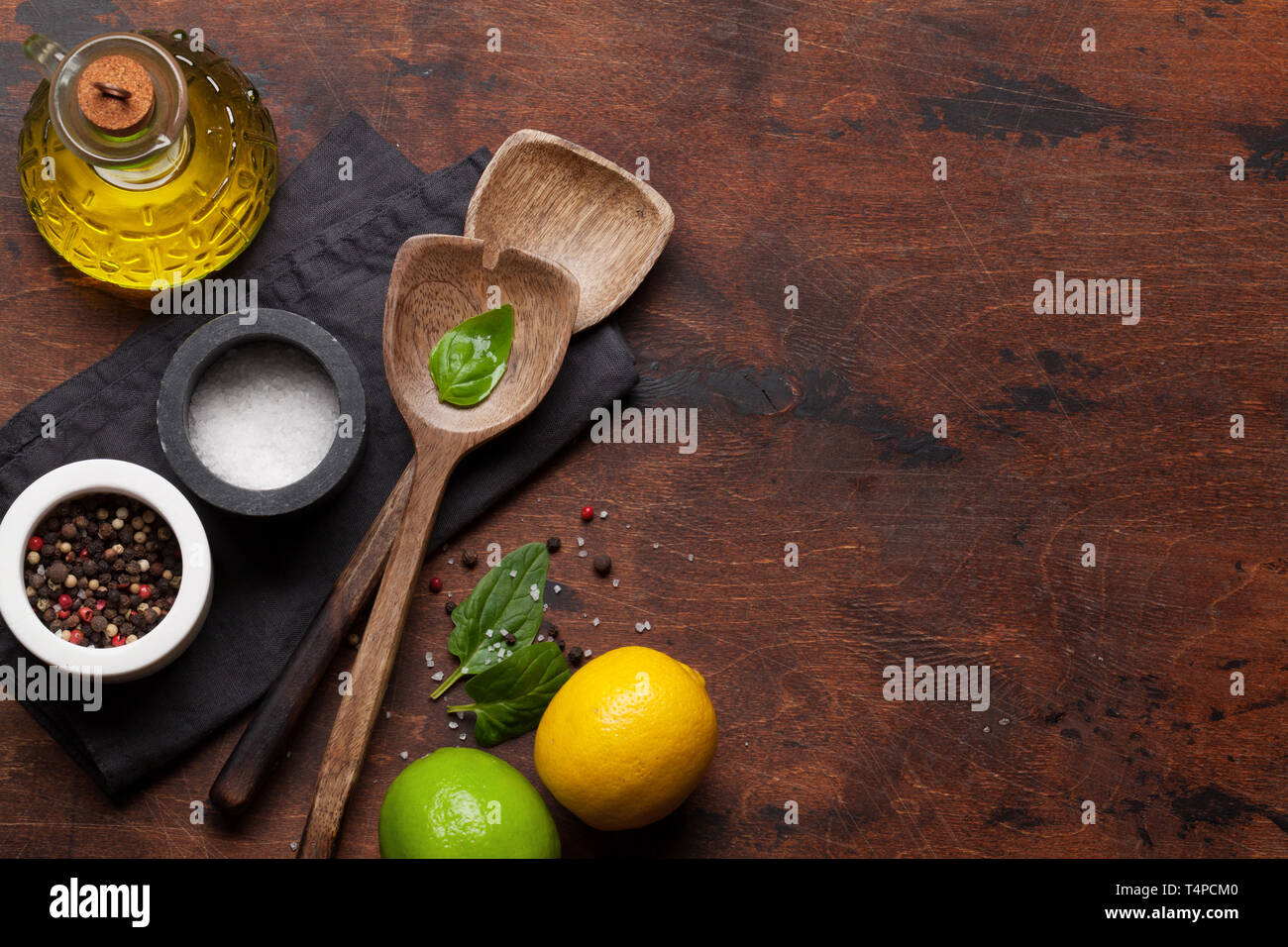 Cooking wooden utensils, condiments and spices on wooden kitchen table ...