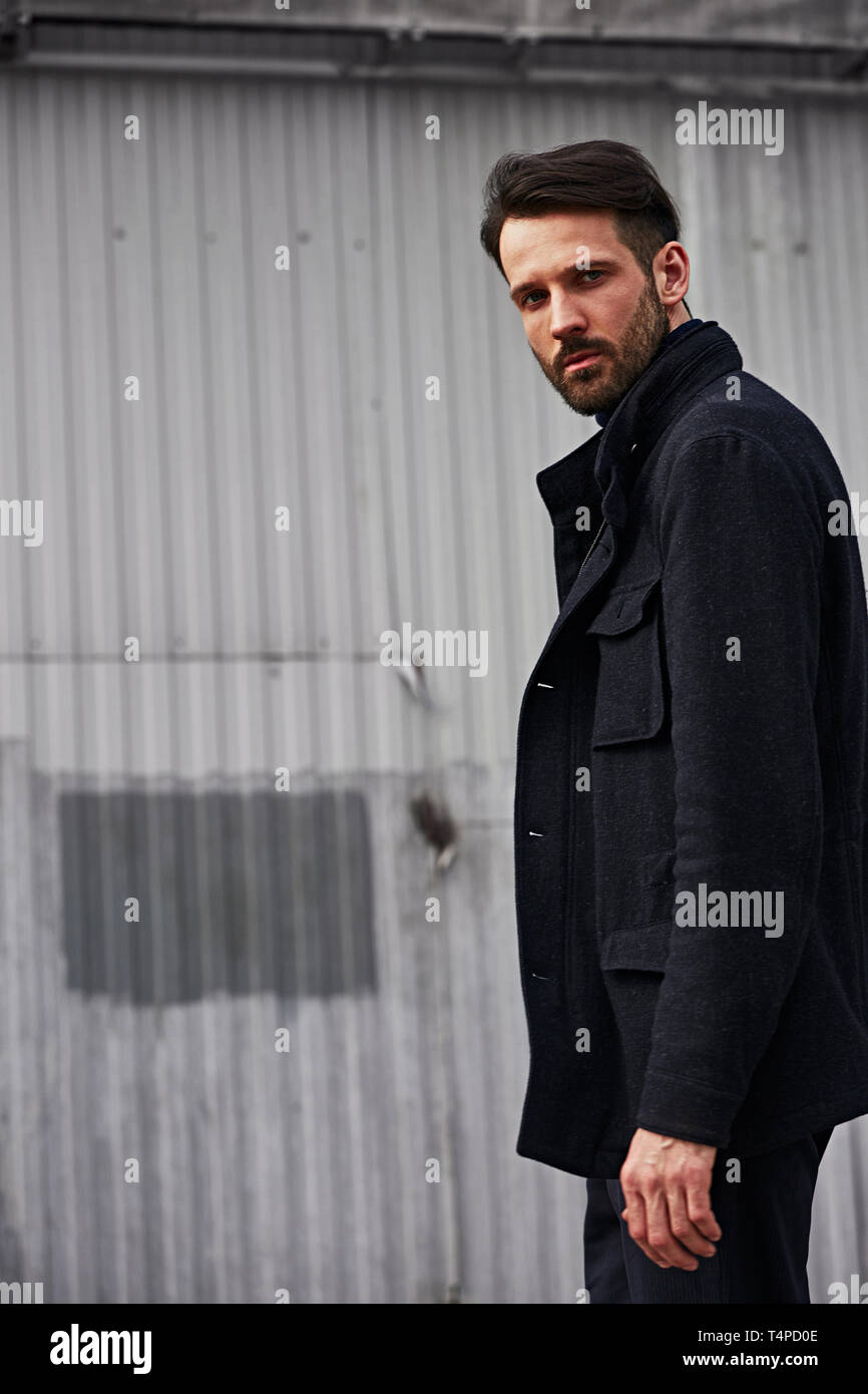 Fashion beard sad handsome male model posing in style clothing blue ...