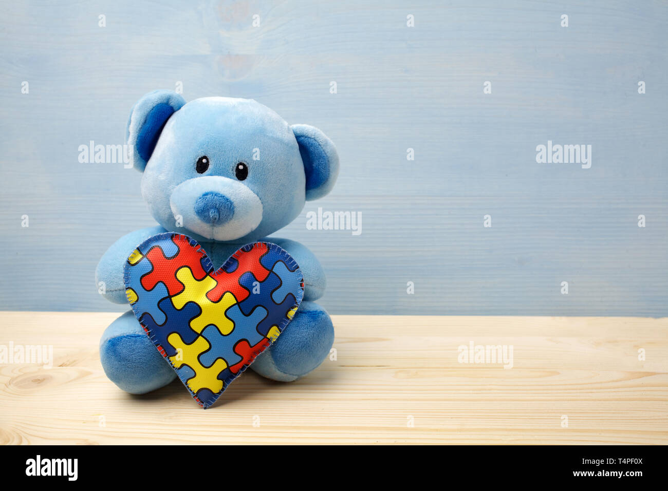 World Autism Awareness day, concept with teddy bear holding puzzle or ...
