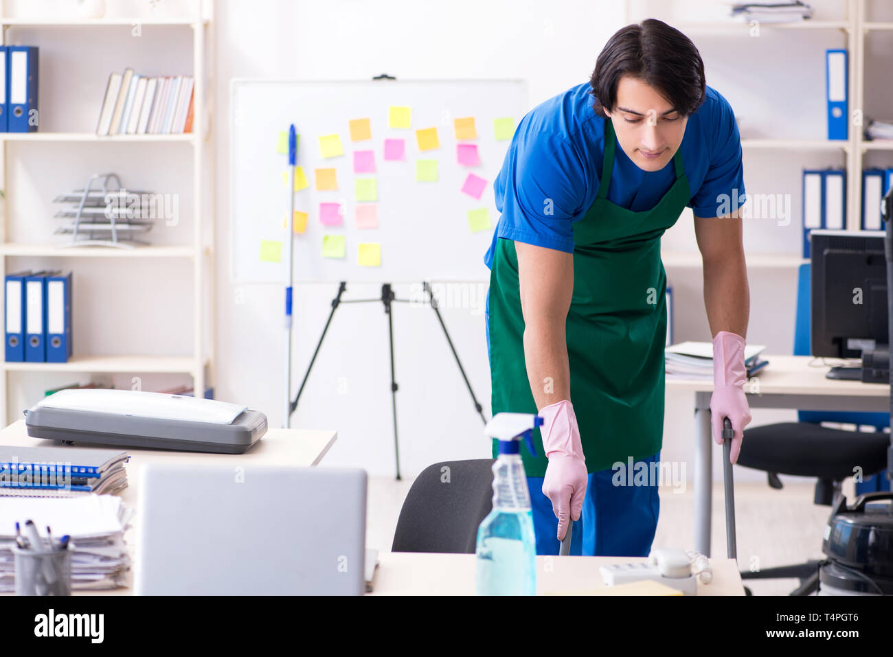 Male handsome professional cleaner working in the office Stock Photo ...