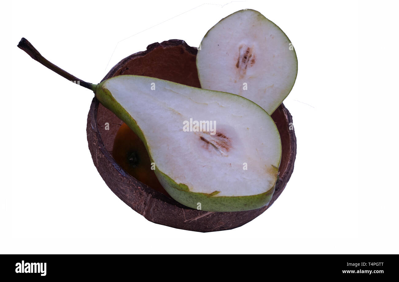Fresh pear in coconut shell on white background Stock Photo - Alamy