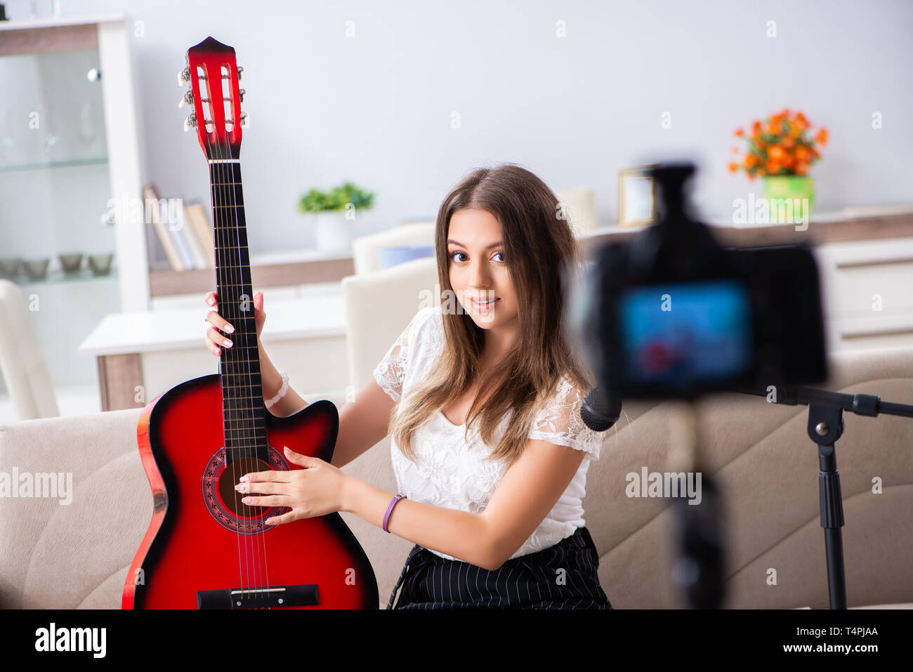 Female beautiful blogger playing guitar Stock Photo - Alamy
