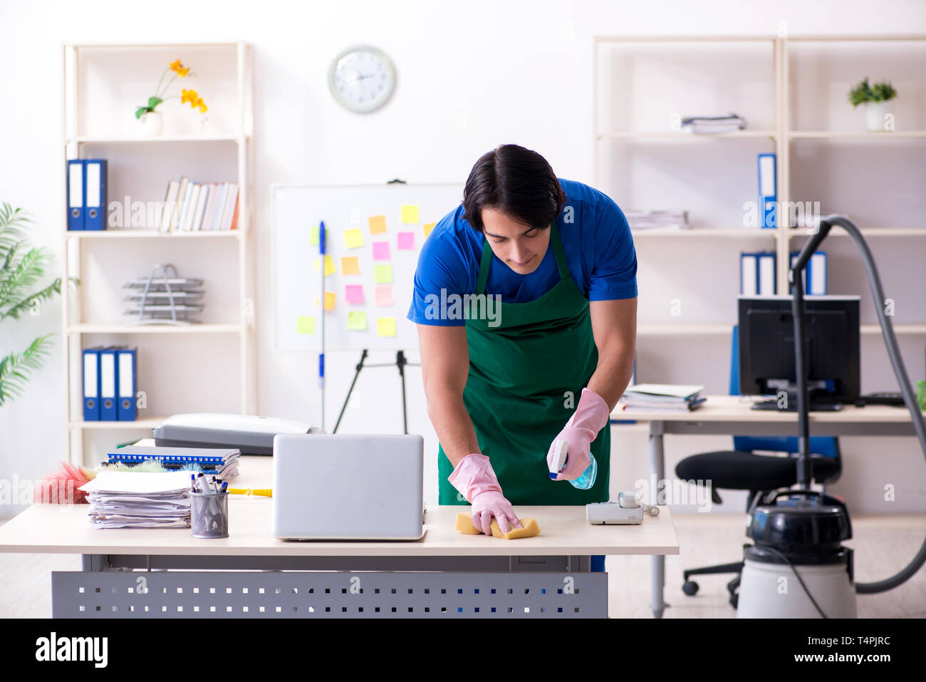 Male handsome professional cleaner working in the office Stock Photo ...