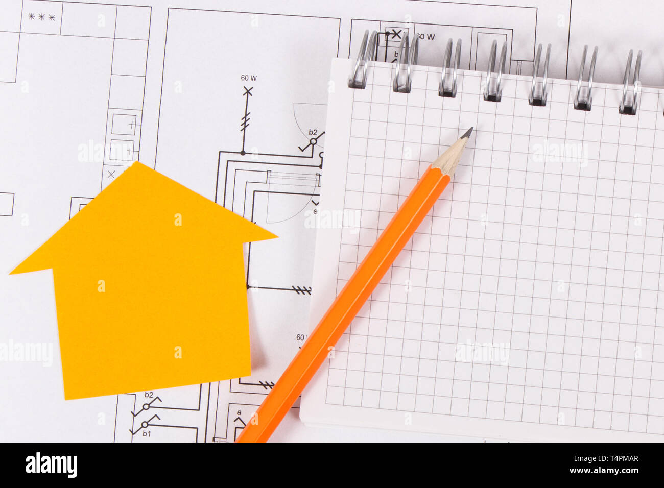 Notepad with pencil for writing notes and home shape on housing plan ...