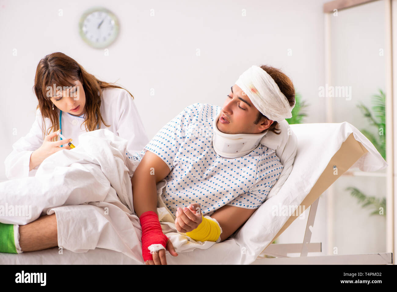 Young doctor examining injured patient Stock Photo - Alamy