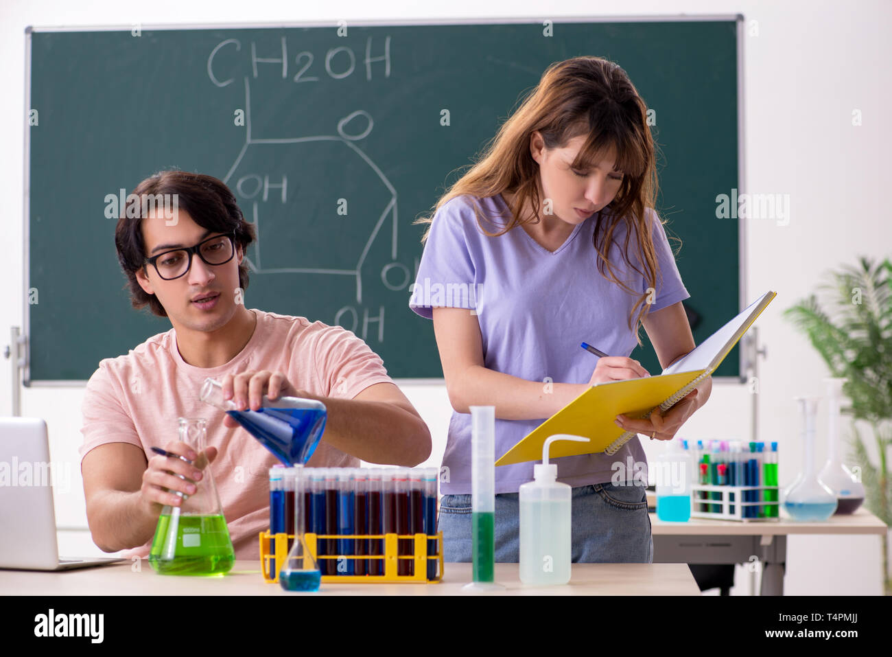 Two chemists students in classroom Stock Photo - Alamy