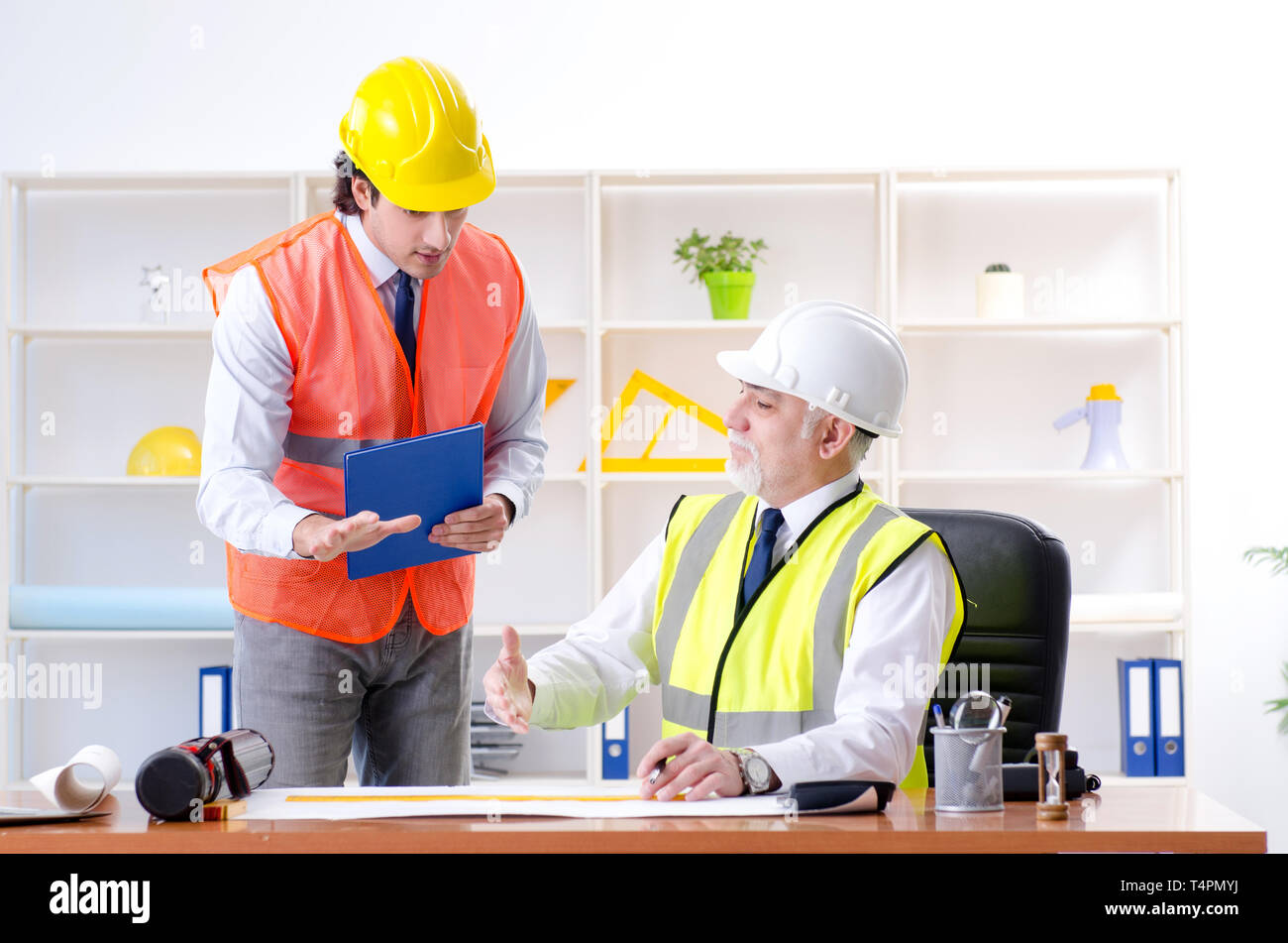 Two engineers colleagues working under project Stock Photo - Alamy