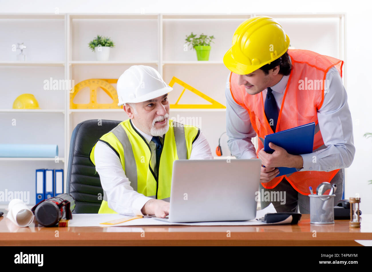 Two engineers colleagues working under project Stock Photo - Alamy