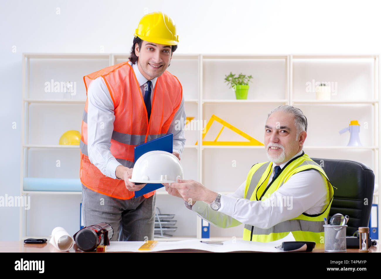 Two engineers colleagues working under project Stock Photo - Alamy