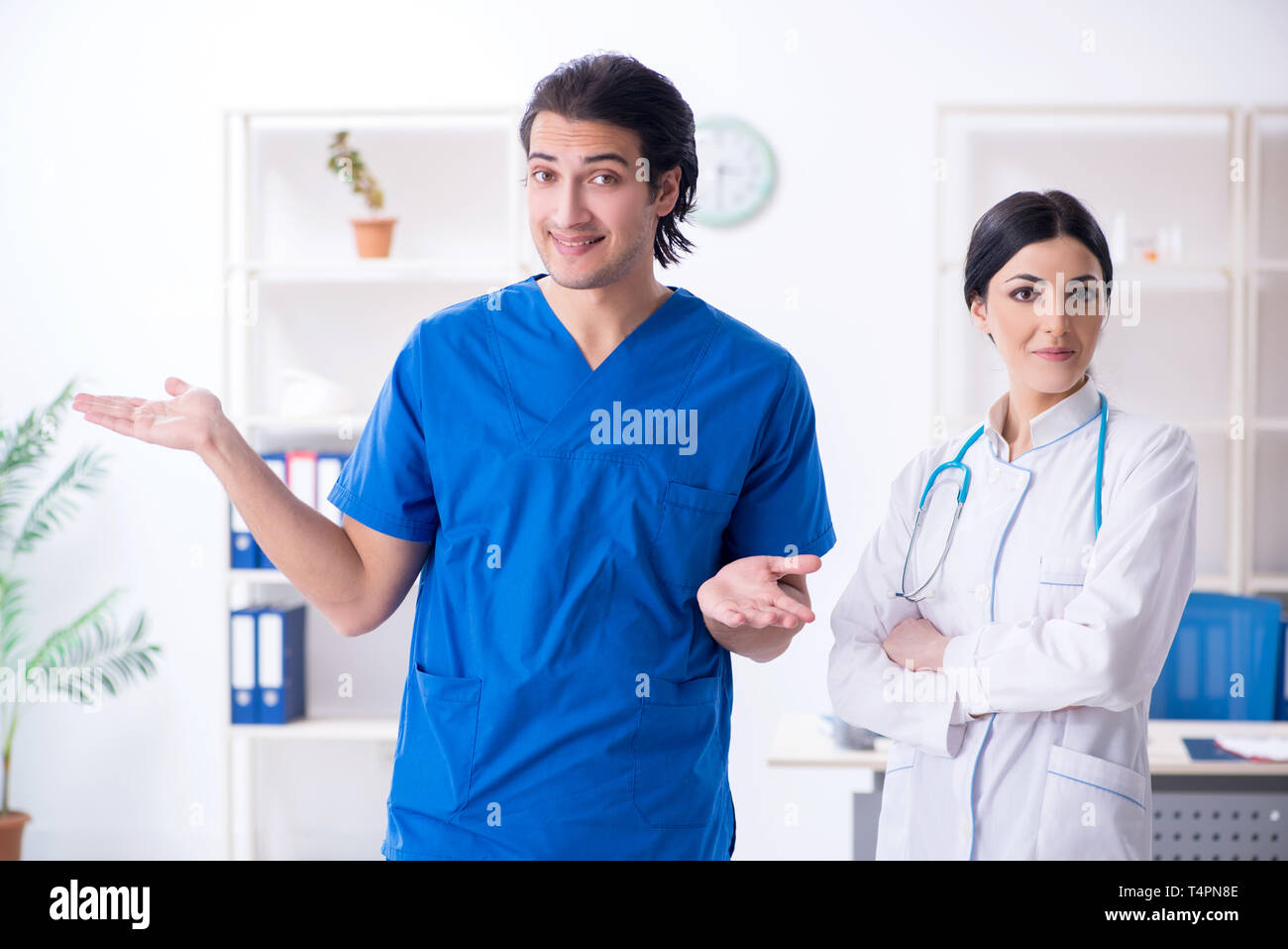 Two young doctors working in the clinic Stock Photo - Alamy