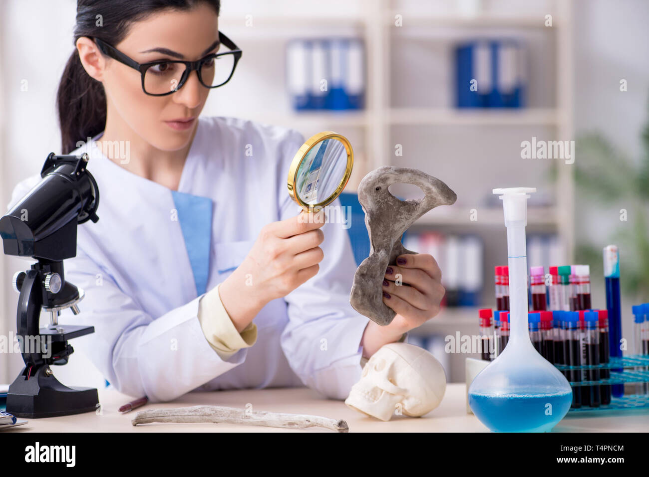 Young female archaeologist working in the lab Stock Photo - Alamy