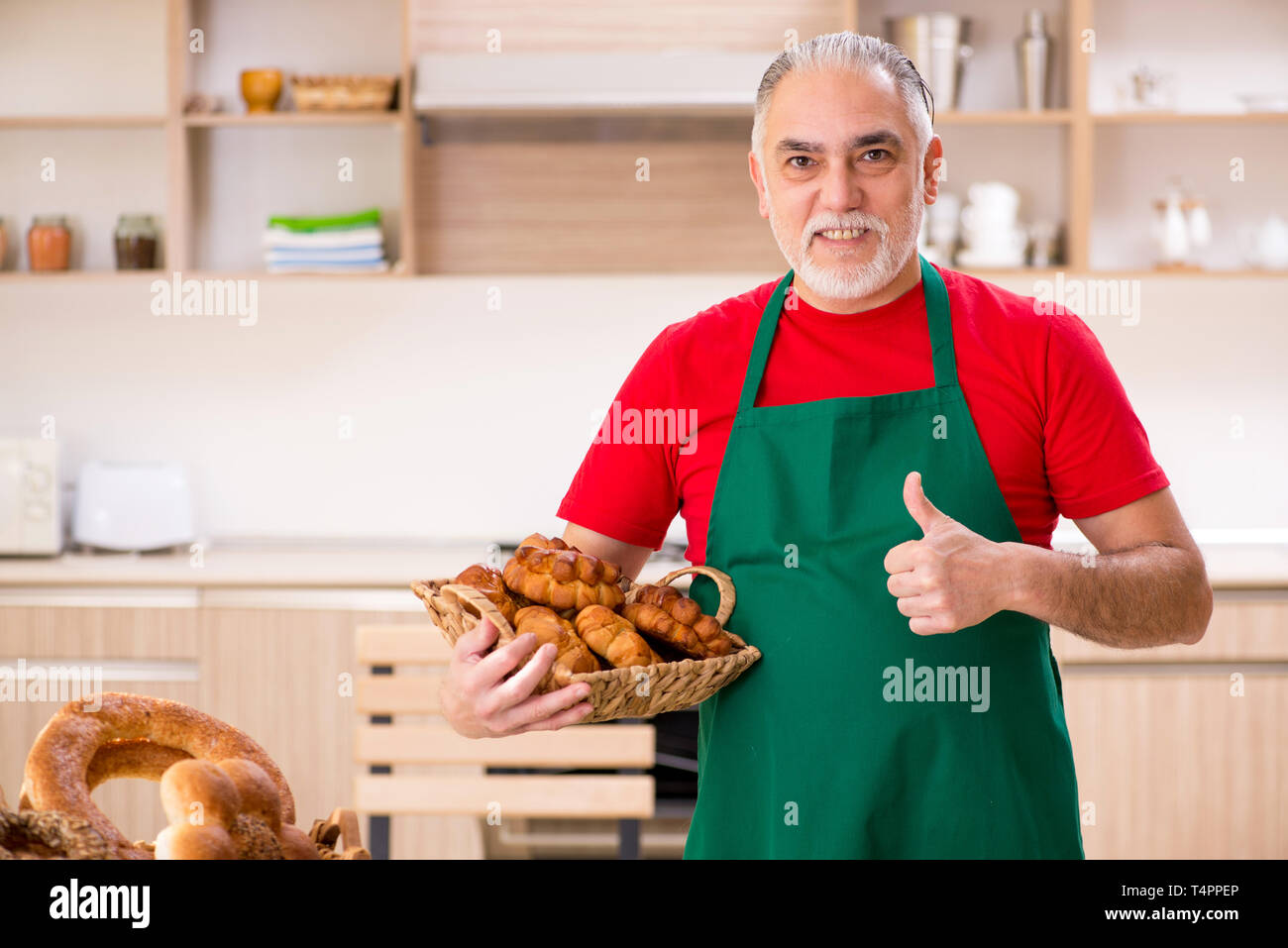 Old male baker working in the kitchen Stock Photo - Alamy