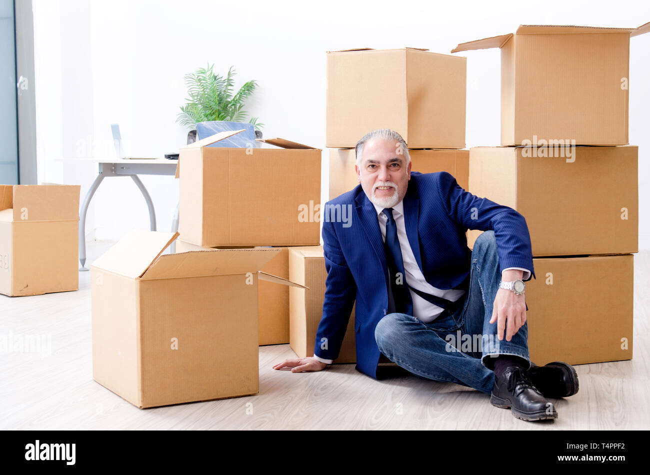 Aged businessman moving to new workplace Stock Photo - Alamy