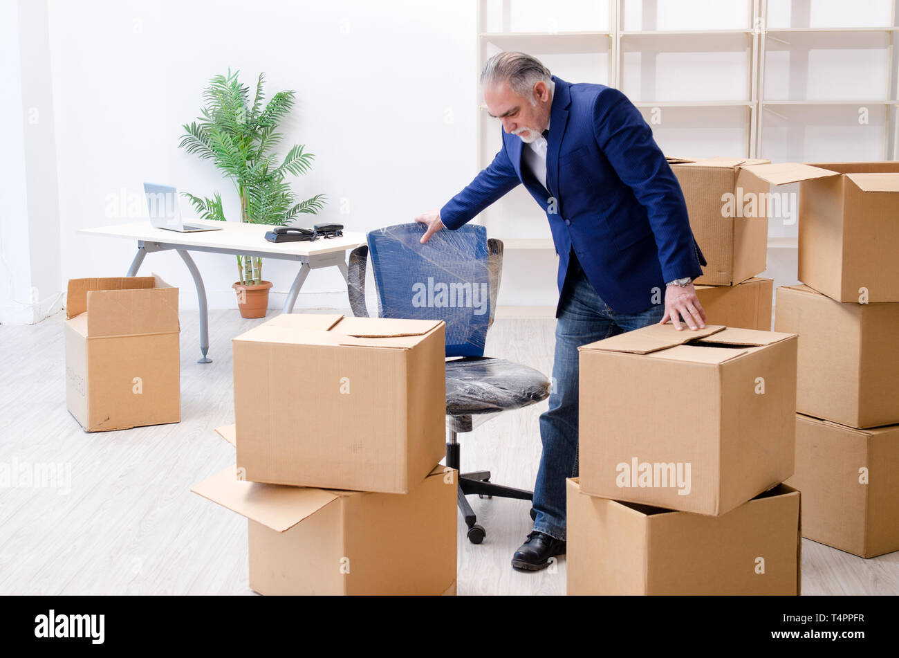 Aged businessman moving to new workplace Stock Photo - Alamy