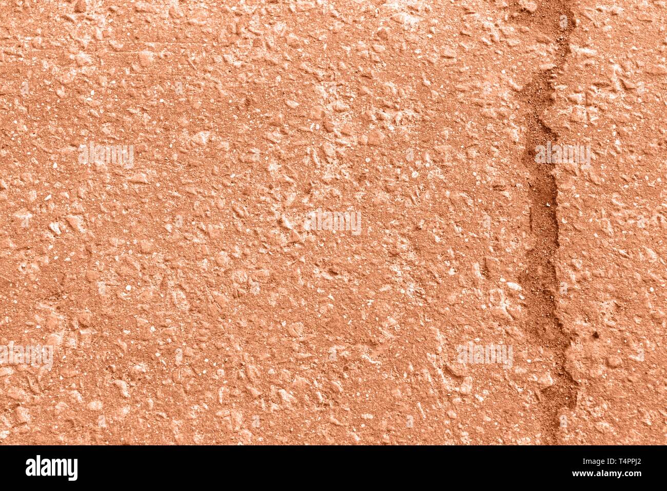 Old asphalt surface texture close up. Orange color toned background ...