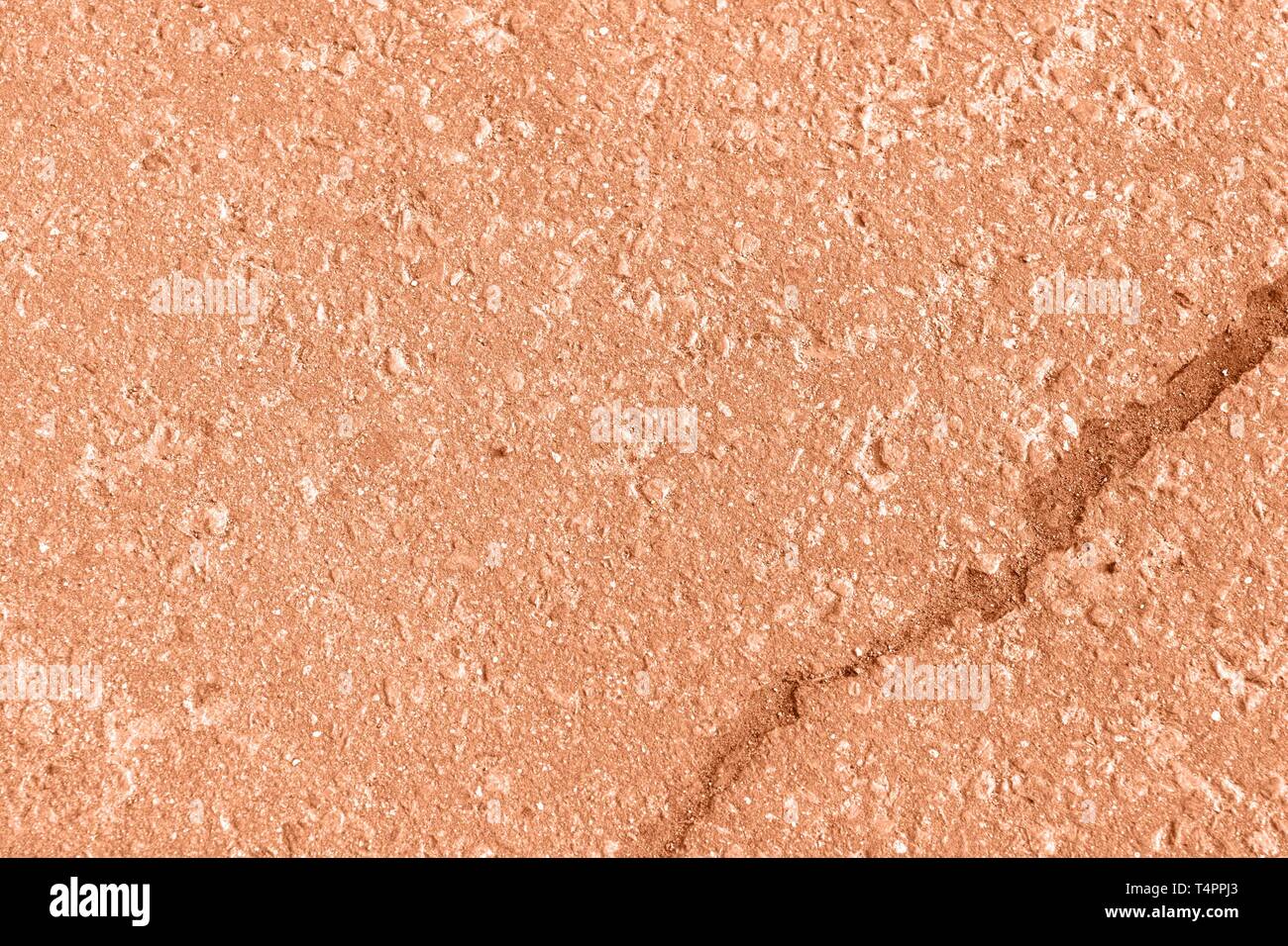 Old asphalt surface texture close up. Orange color toned background ...