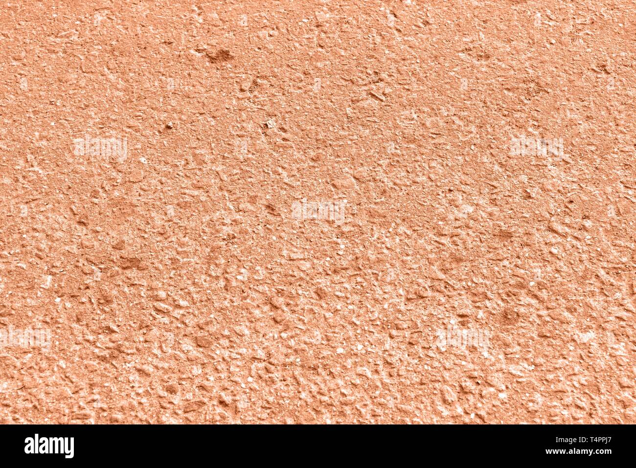 Old asphalt surface texture close up. Orange color toned background ...