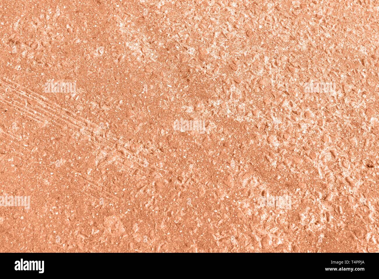 Old asphalt surface texture close up. Orange color toned background ...