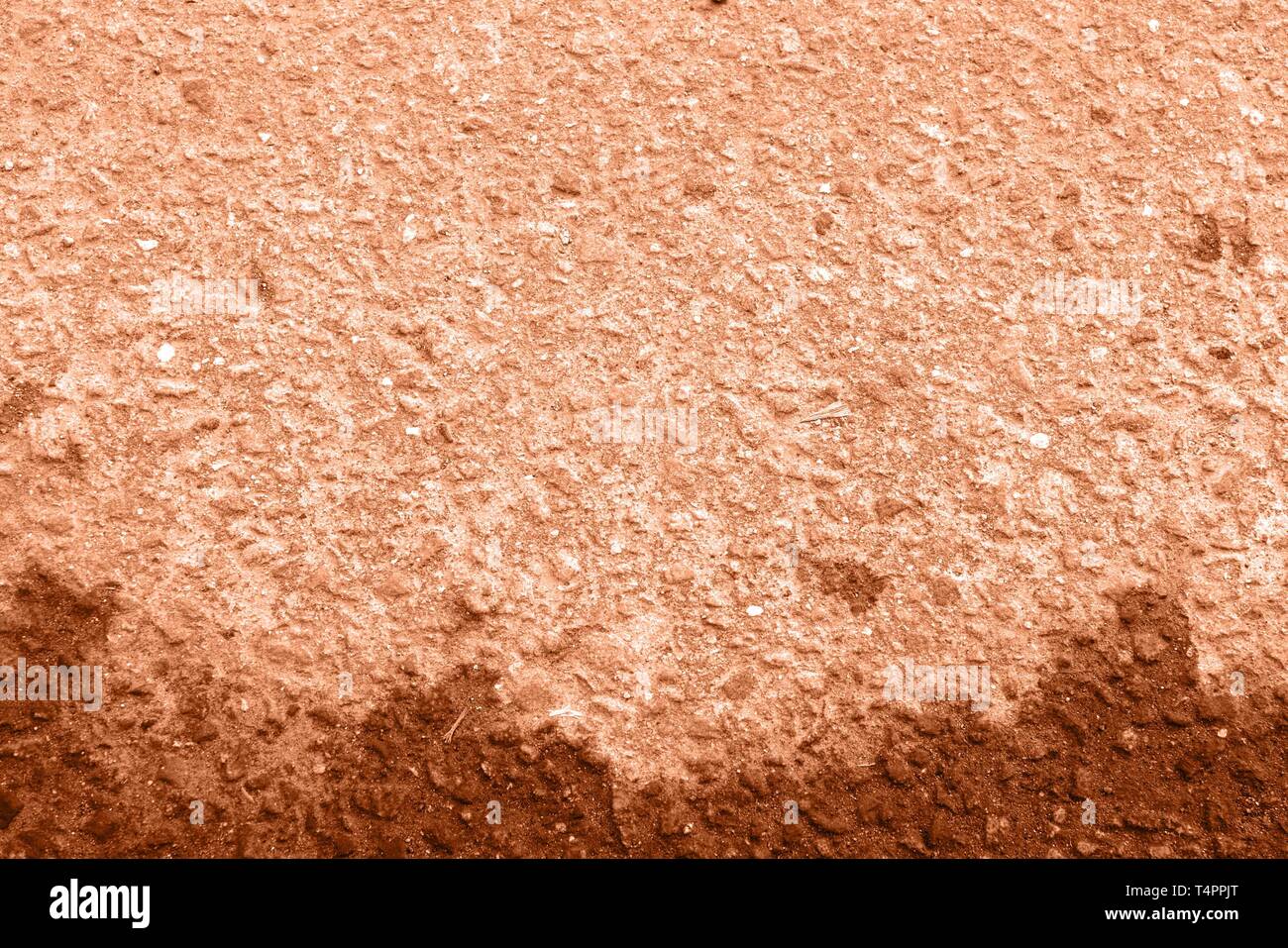 Old asphalt surface texture close up. Orange color toned background ...