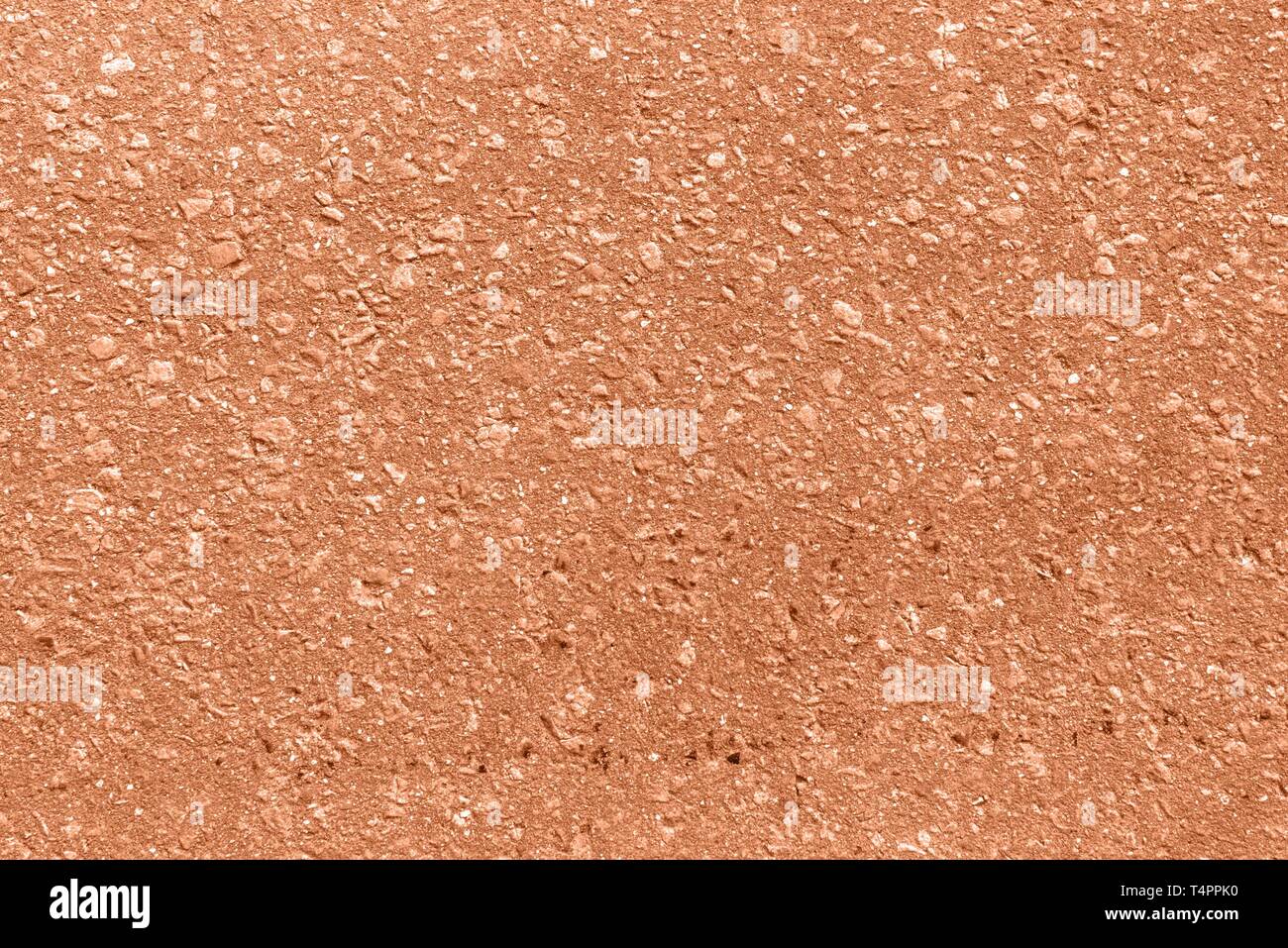 Old asphalt surface texture close up. Orange color toned background ...