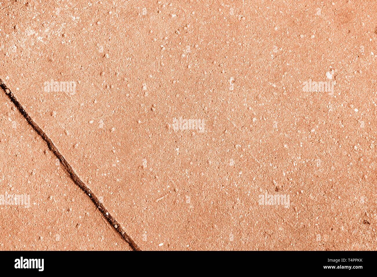 Old asphalt surface texture close up. Orange color toned background ...