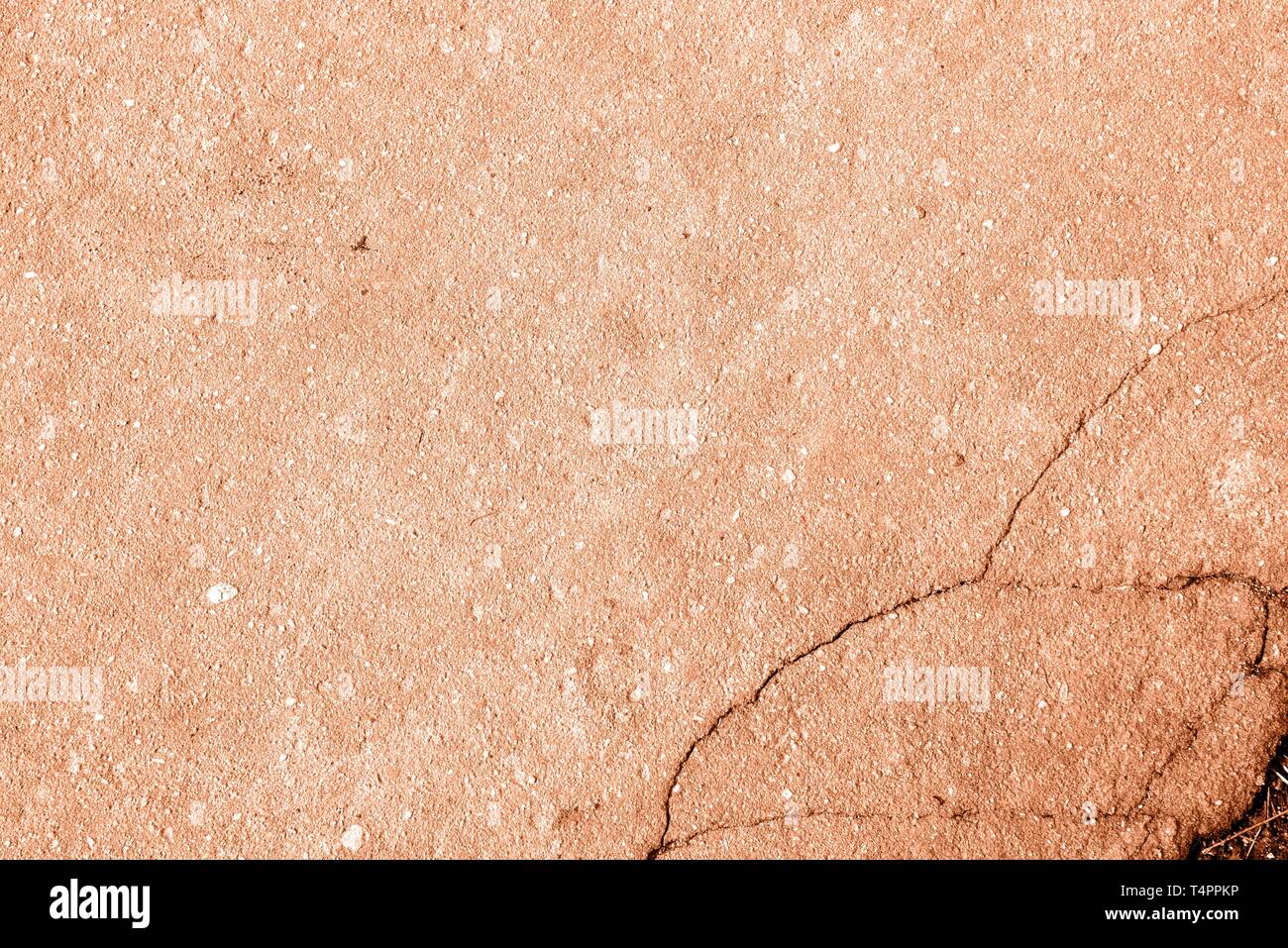 Old asphalt surface texture close up. Orange color toned background ...