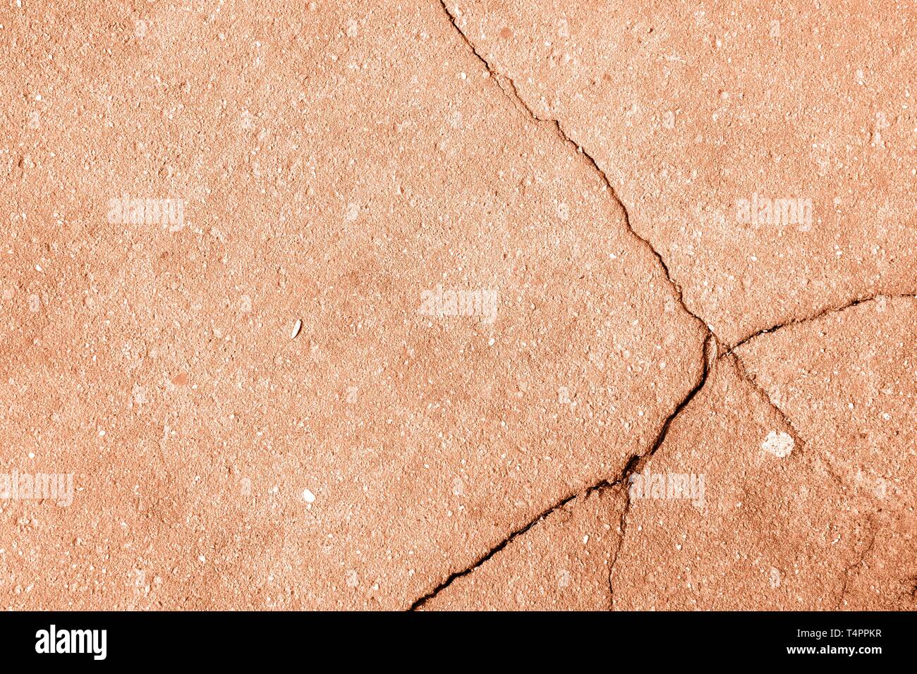 Old asphalt surface texture close up. Orange color toned background ...