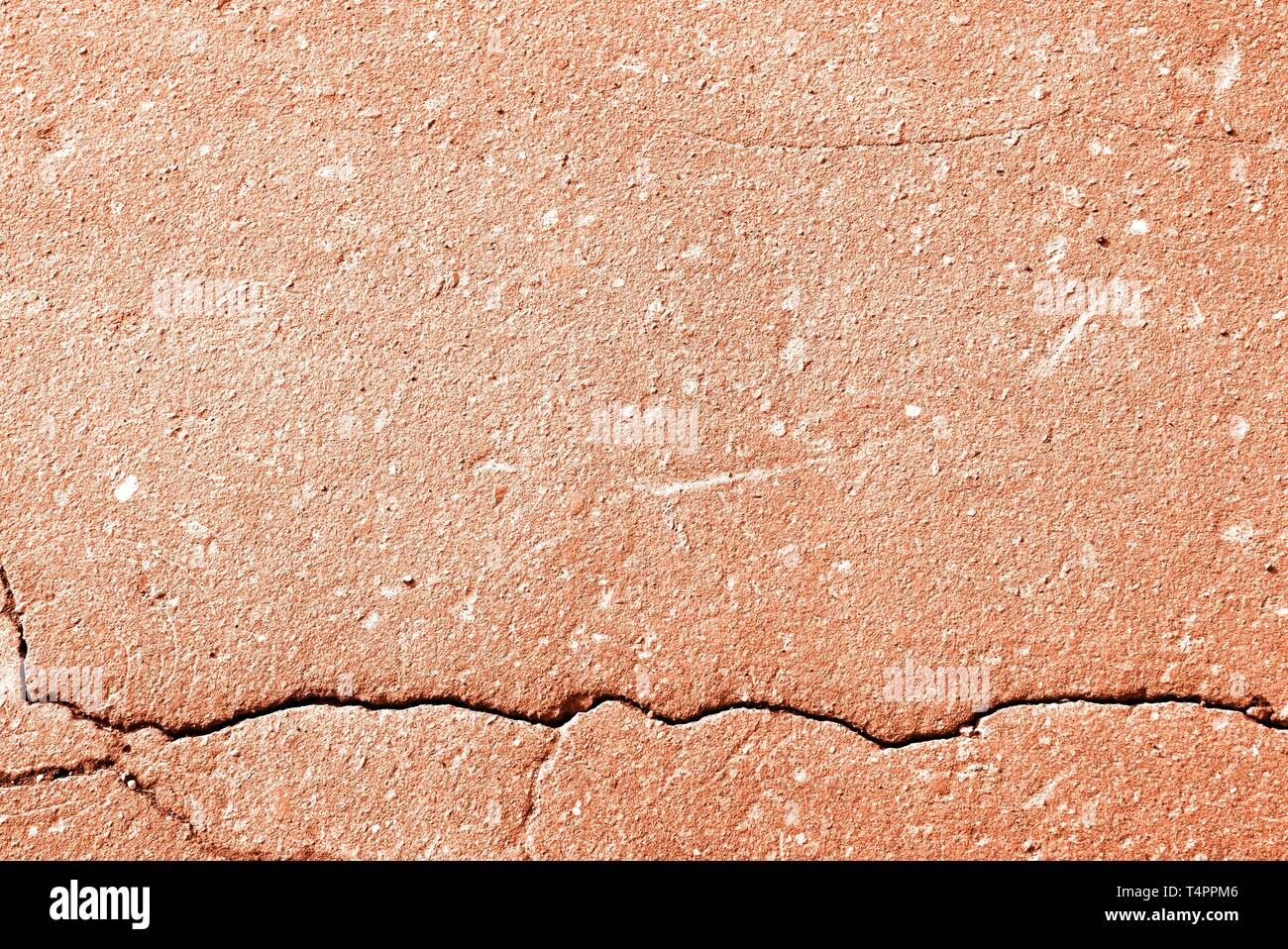 Old asphalt surface texture close up. Orange color toned background ...
