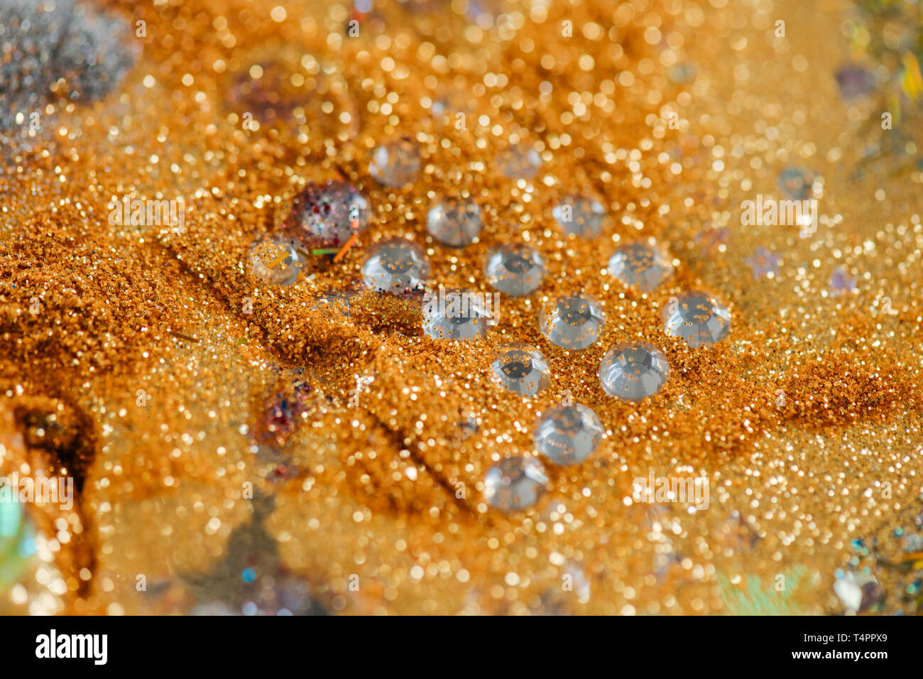Mess around. Paper with gluer transparent fake crystals being ...