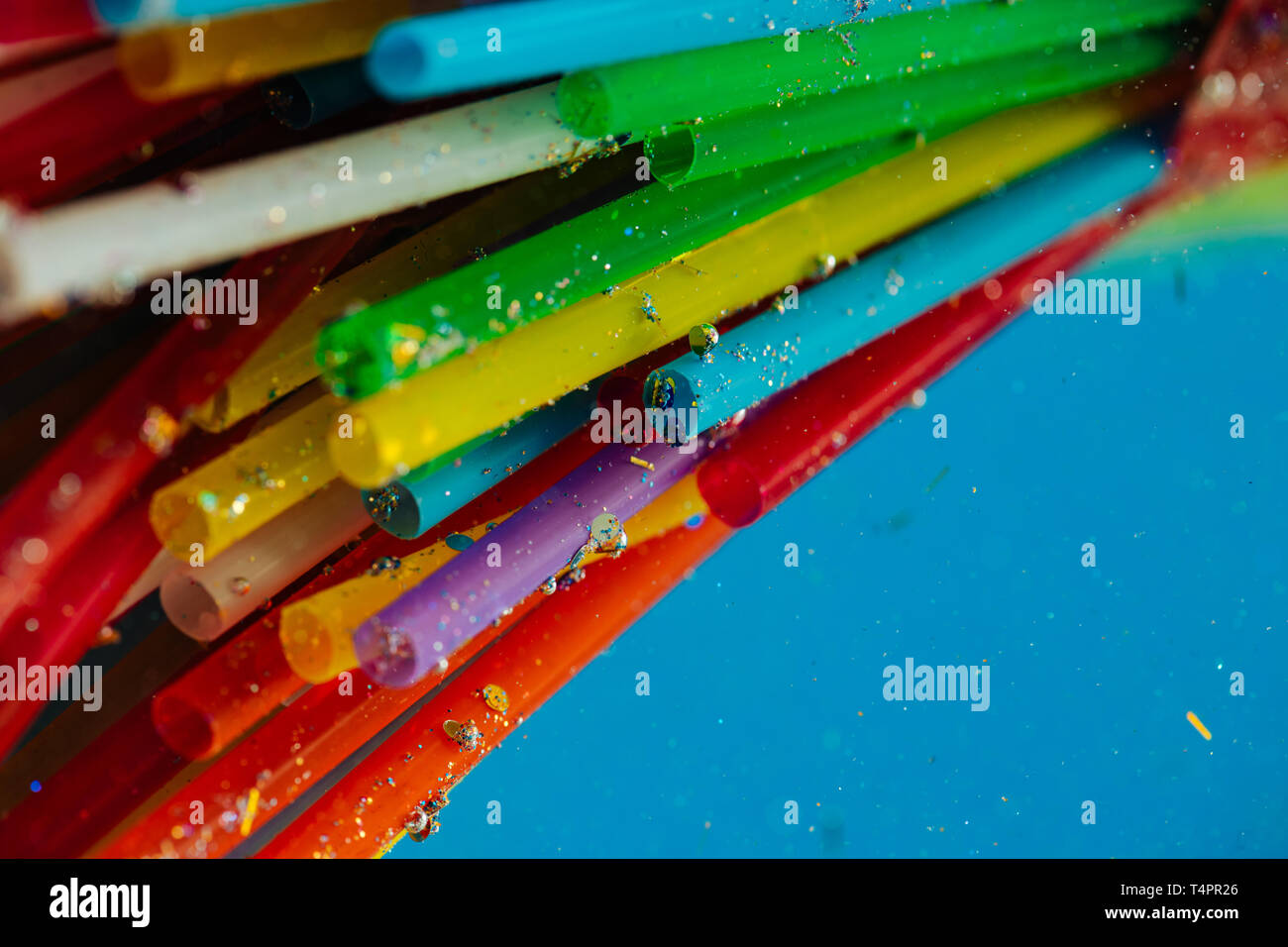 Polluting oceans. Bright toxic cocktail straws made of dangerous ...