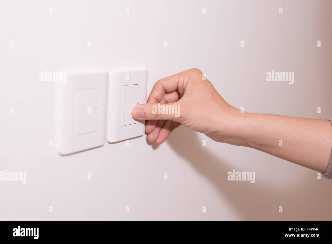 people pressing button for light on wall Stock Photo - Alamy