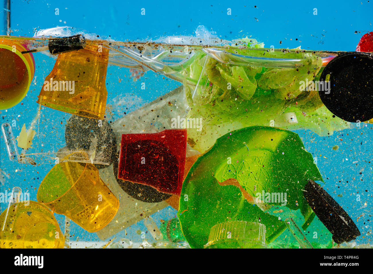 Plastic mess floating. Crumpled green bags being mixed with disposal ...